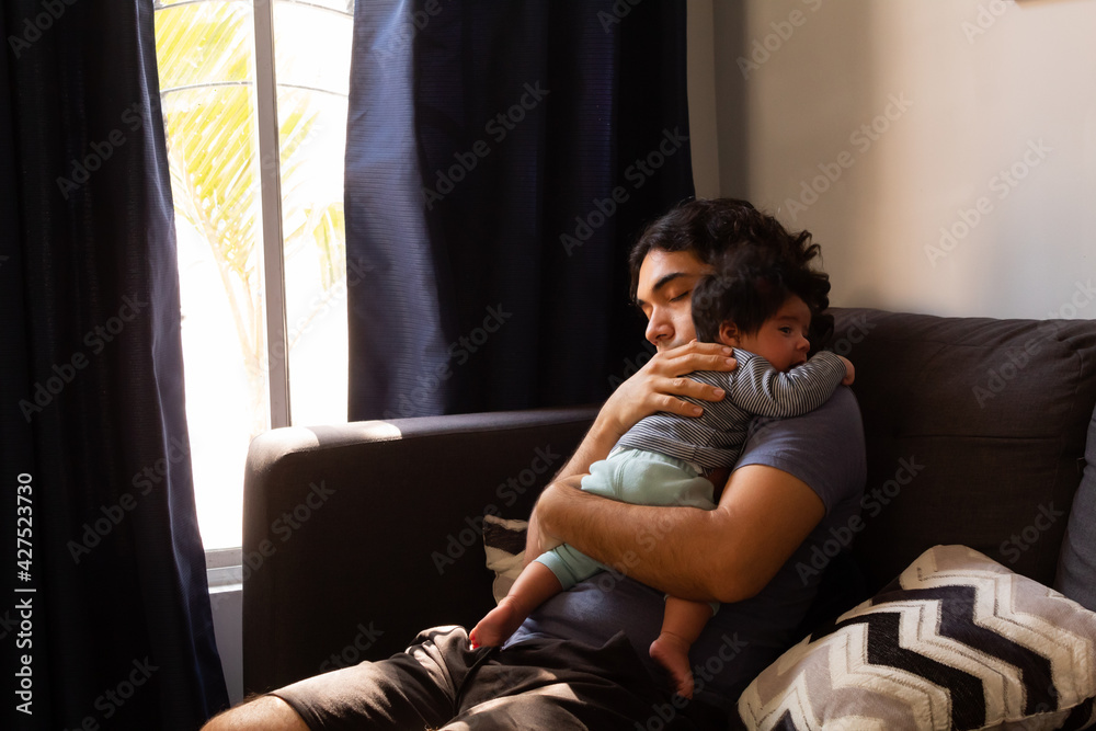 young happy hispanic father hugging and holding his newborn baby Stock ...