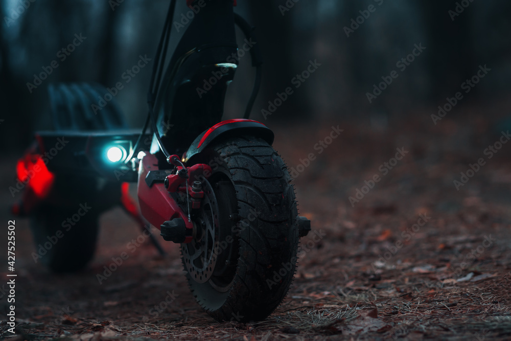 Powerful modern all-wheel drive electric scooter in the evening with ...