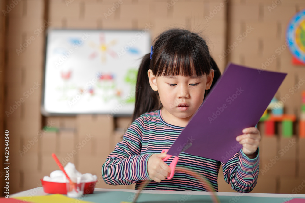 young girl making paper craft for homeschooling Stock Photo | Adobe Stock