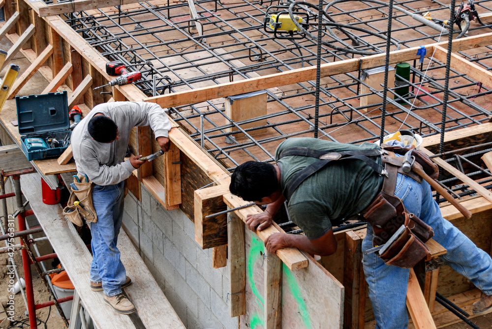 Carpenters setting wood forms on a new deck Stock Photo | Adobe Stock
