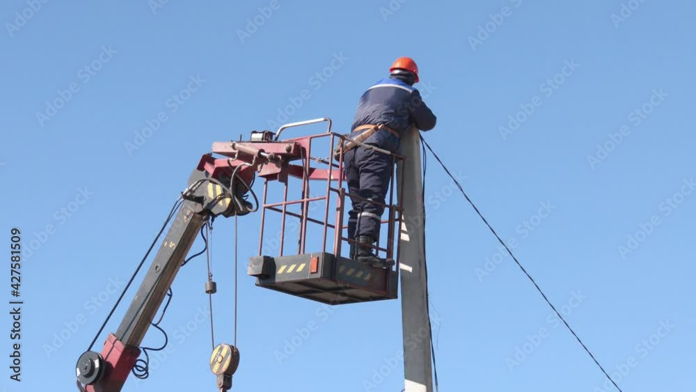 Electricians Wiring Cable repair services, worker in crane truck bucket ...