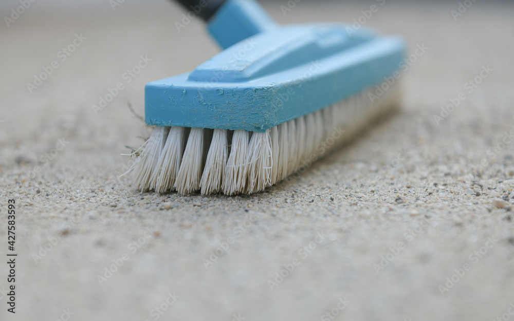 Garden broom. Tools for landscaping. Cleaning the pavers from sand ...