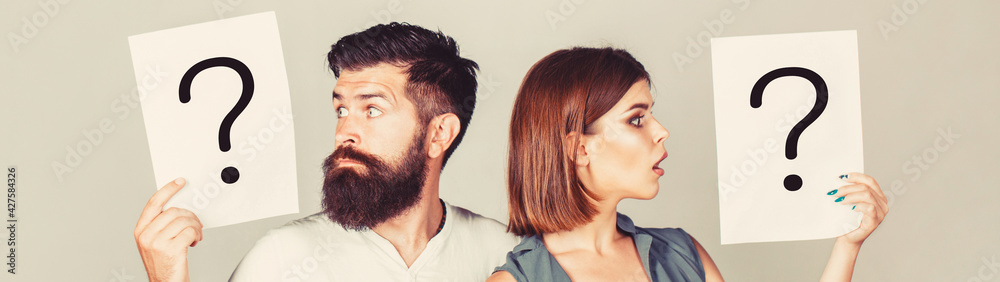 Portrait of couple holding paper question mark. Couple thinking about ...