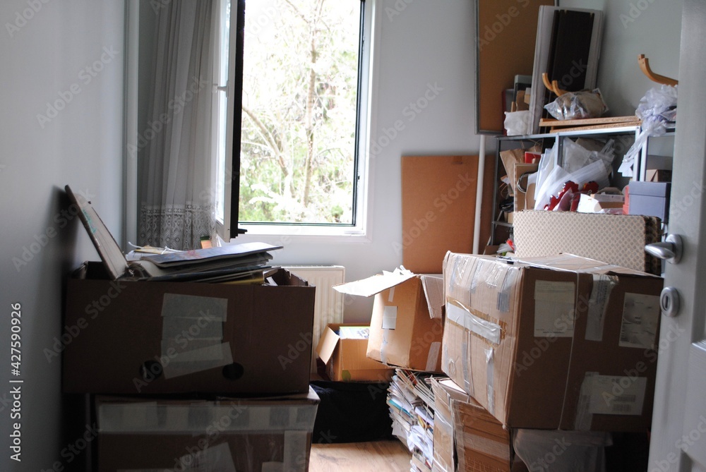 Moving packing concept. A room full of messy cardboard boxes with an ...