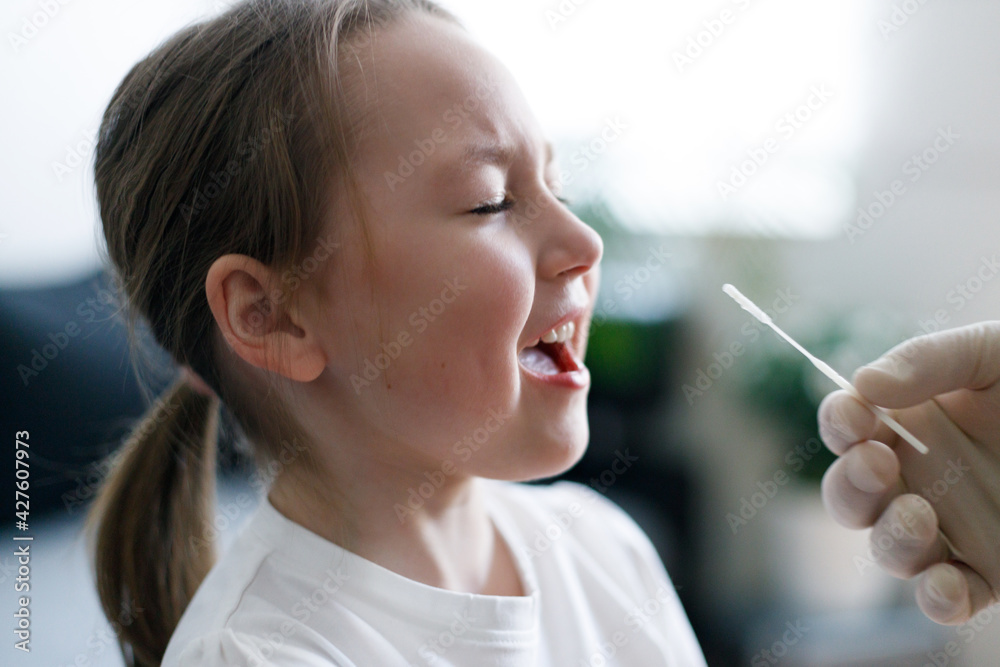 Little girl at home crying during taking nasal mucus test showing Covid ...