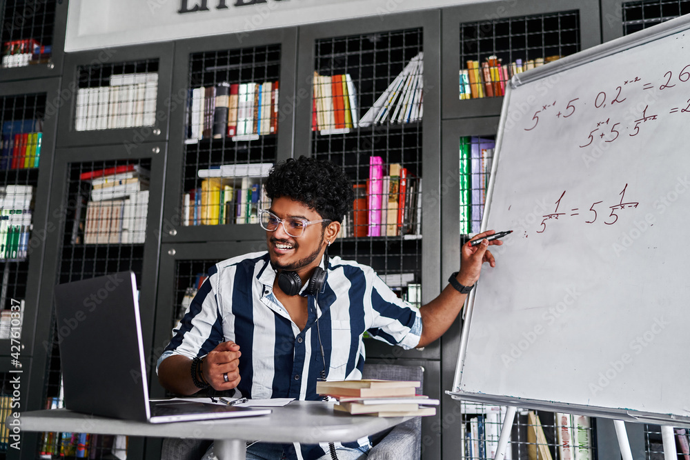 Smiling Indian young teacher, online learning, distance learning ...