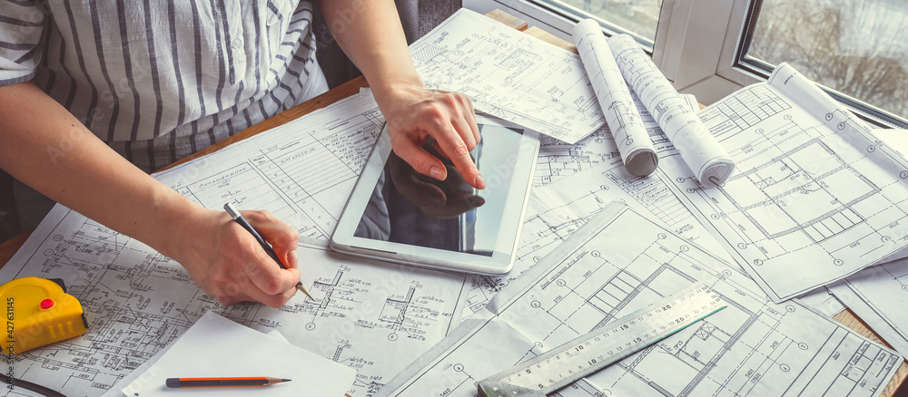 Architect works remotely from home in quarantine, lockdown covid 19 coronavirus. Remote work ...