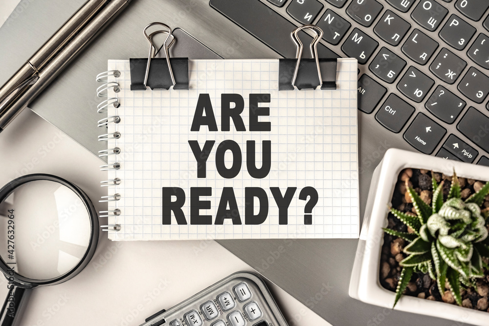 ARE YOU READY text on a notepad and laptop, office tools. Business ...