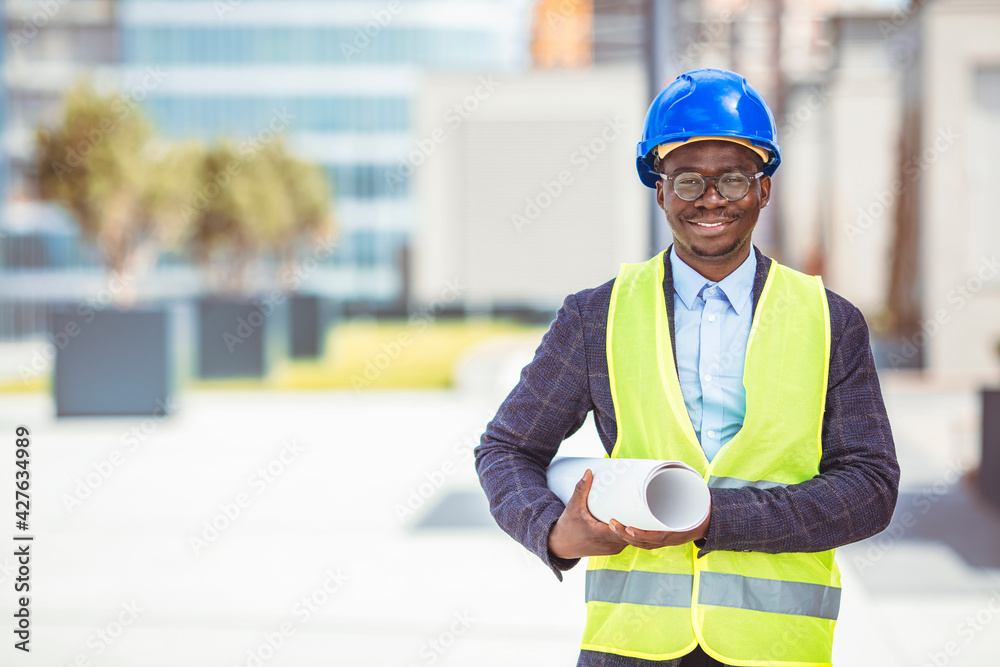Successful male architect at building site looking at camera. Confident ...