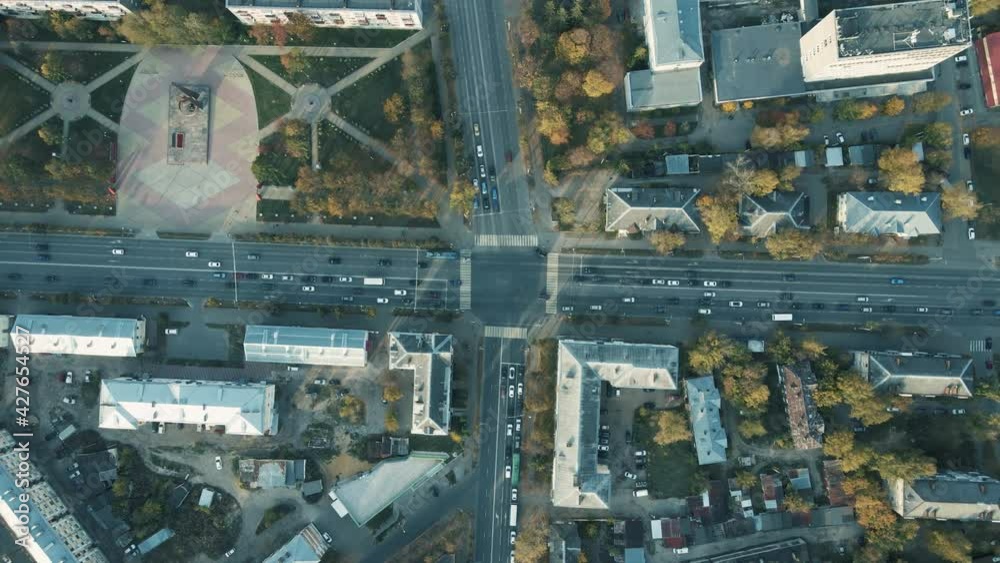 A wide city road intersection in the morning a lot of cars pass ...