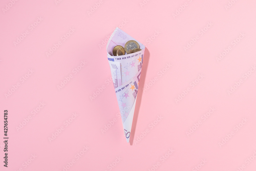 Horn from euro denominations with fine coins on a pink background ...