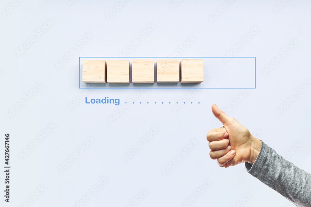 Ok gesture next to the progress bar filling with wooden cubes. Loading ...