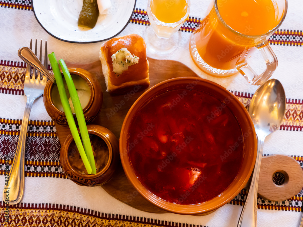 Ukrainian borscht traditionally served with garlic pampushky, minced ...