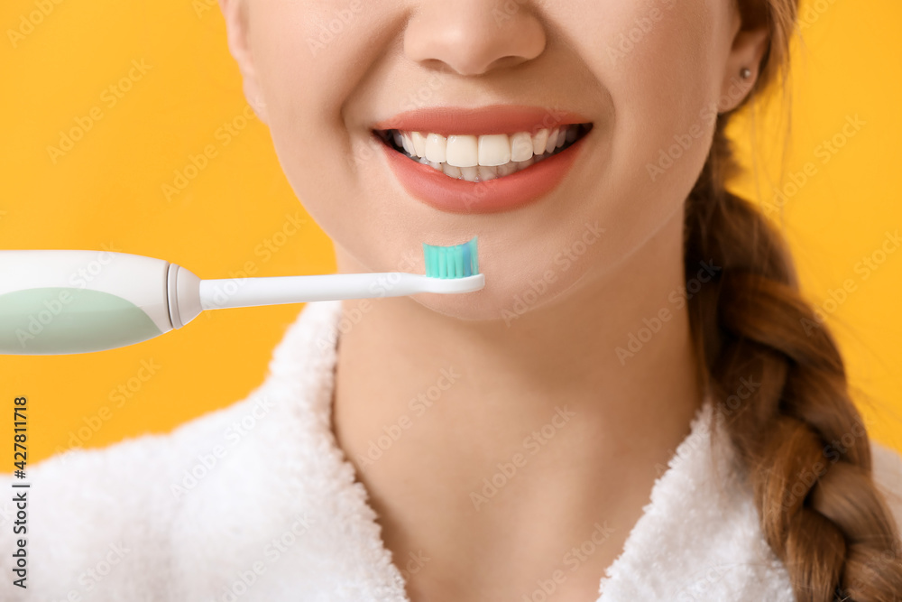 Young woman brushing teeth on color background, closeup Stock Photo ...