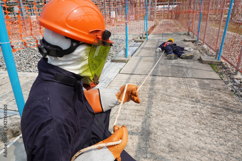 Rescuers' hands are pulling a rope to save worker an electric shock ...