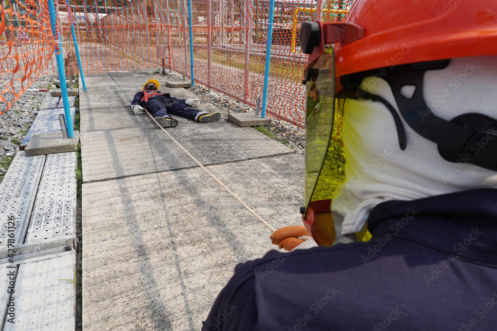 Rescuers' hands are pulling a rope to save worker an electric shock ...