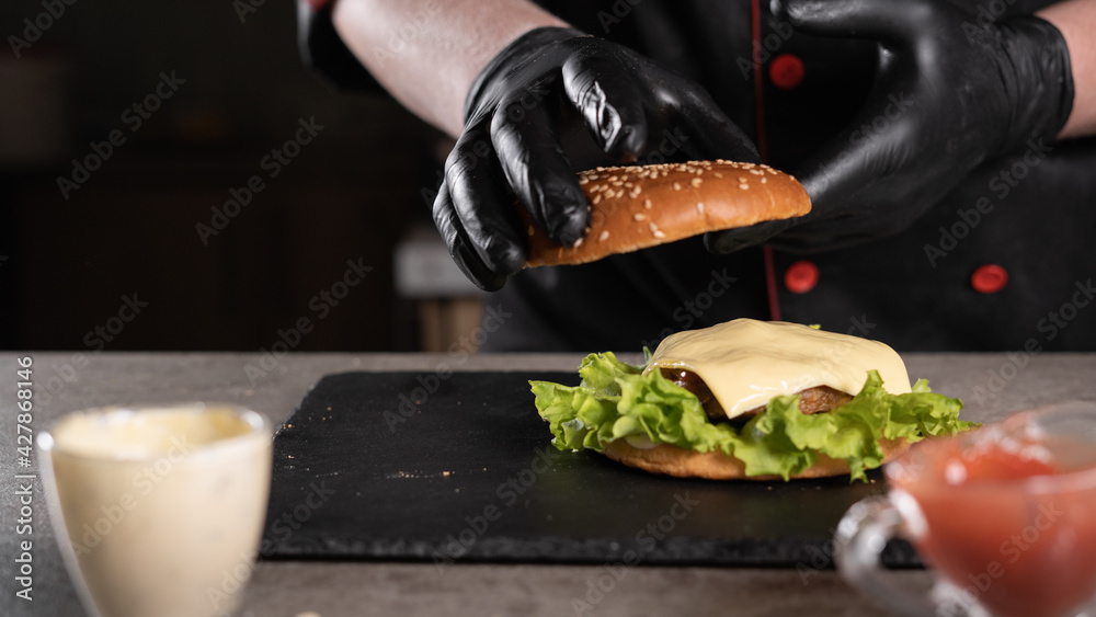 step by step recipe. Stage 8. The chef prepares a delicious burger ...