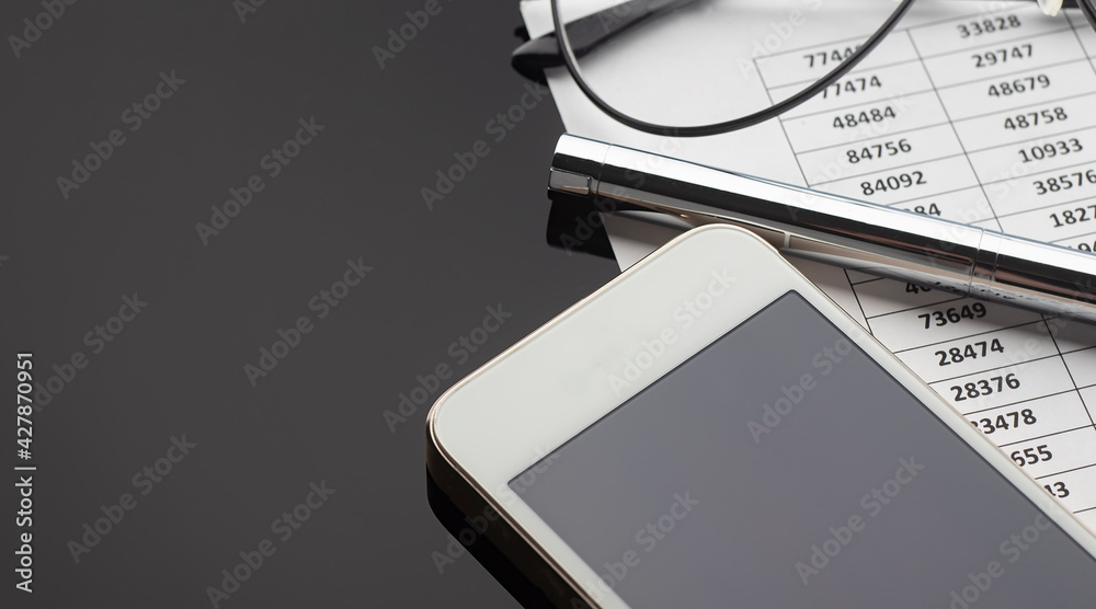 Office desk table with smartphone ,chart,pen and glassess. Top view ...