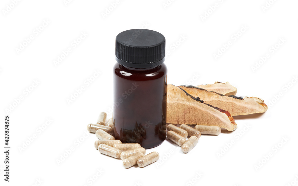 Ganoderma lucidum capsules with dark bottle and sliced fresh Ling zhi ...