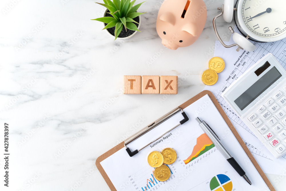 Top view of calculating and paying tax concept on marble white table ...