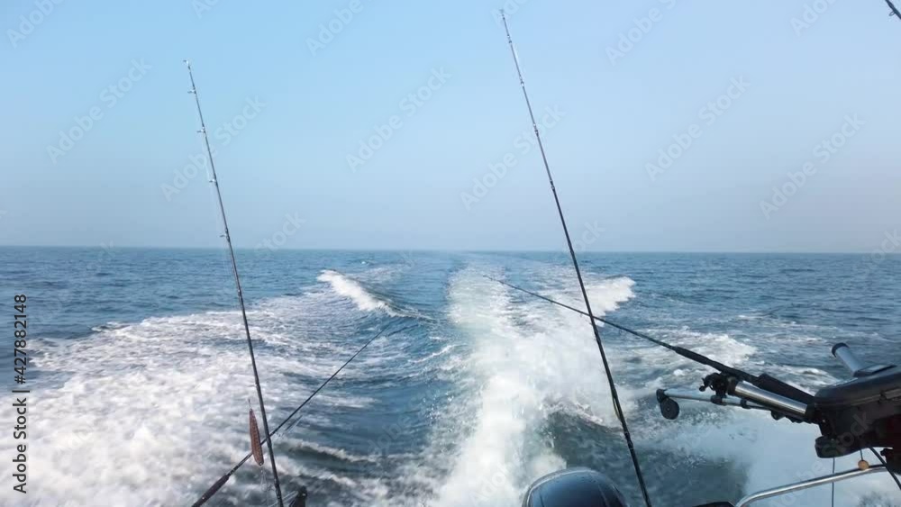 Fast fishing boat creating splashing waves at sea. Boat sail fast over ...