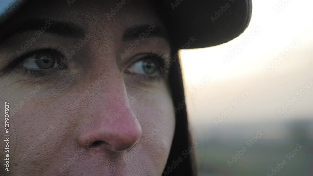 Portrait of young woman looking up at sunset sky. Woman wants a dream ...