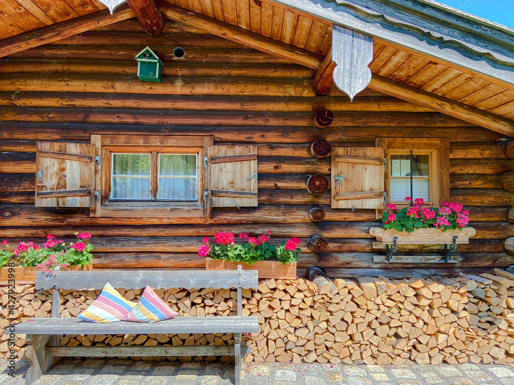 Bavarian log cabin with wooden bench and flowers, Rottach-Egern ...