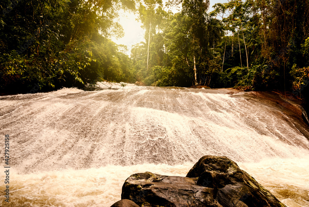 Tobogan waterfall illuminated by the sun's rays. Tourist spot in the ...