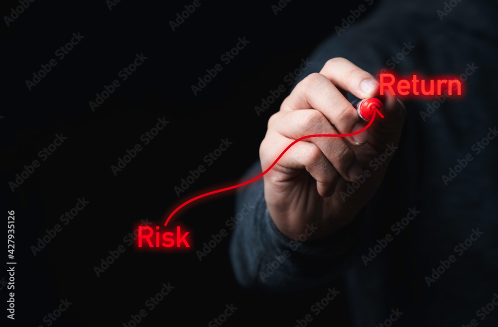 Businessman drawing red arrow and risk return wording, Investment ...
