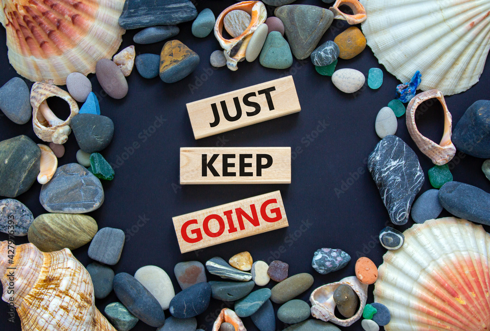 Just keep going symbol. Wooden blocks with words 'Just keep going ...