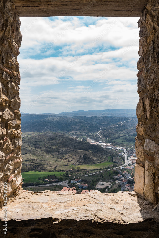 Stone window of a medieval castle from which you can see the horizon ...