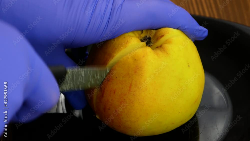 Removing the rot from the apple. Cutting the rot out of a fresh apple ...