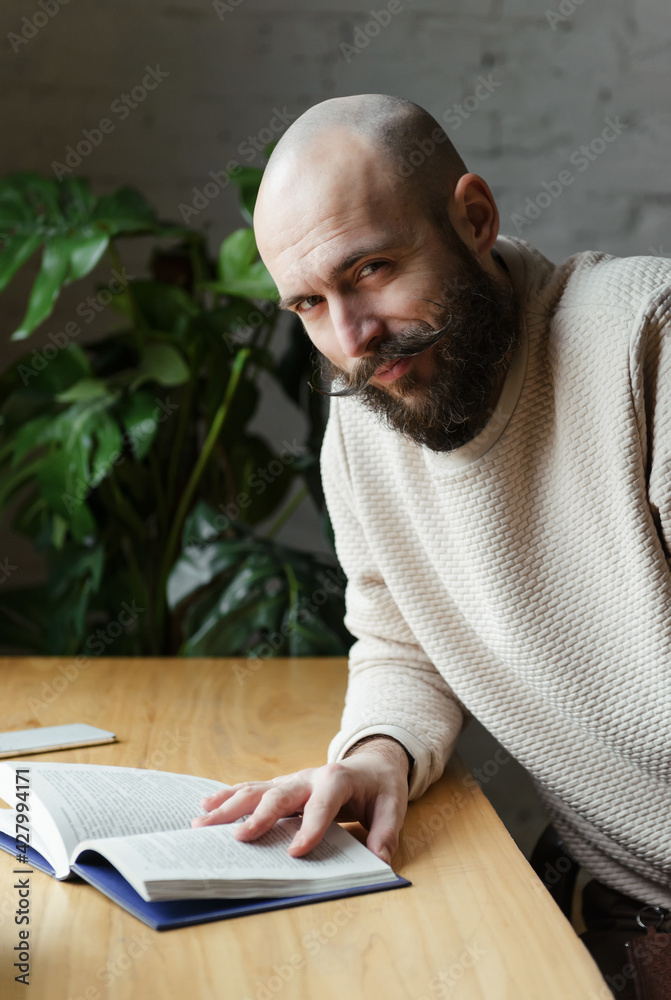 bald man 35 years old with a beard and mustache in a beige jumper with ...
