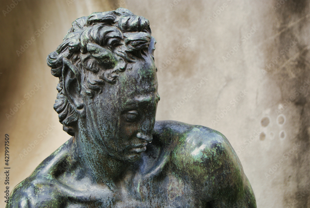 Closeup of the statue of a satyr. Beautiful bronze statue representing ...