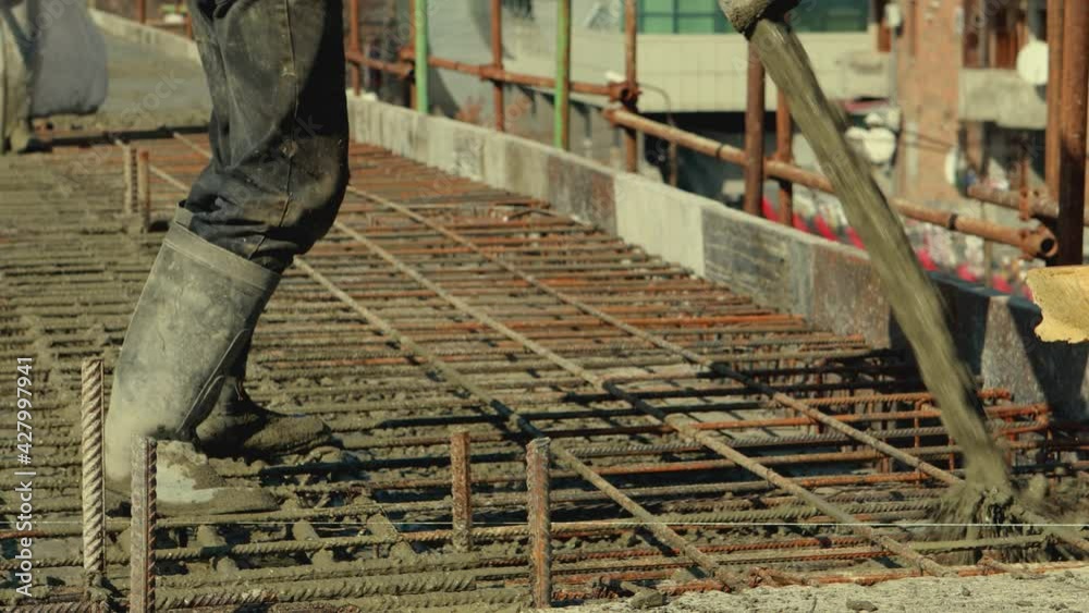 Engineers Pouring Concrete reinforcement into a floor metallic ...
