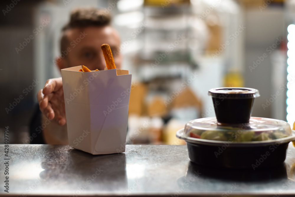 Restaurant employee placing take out order on a pick up window Stock ...