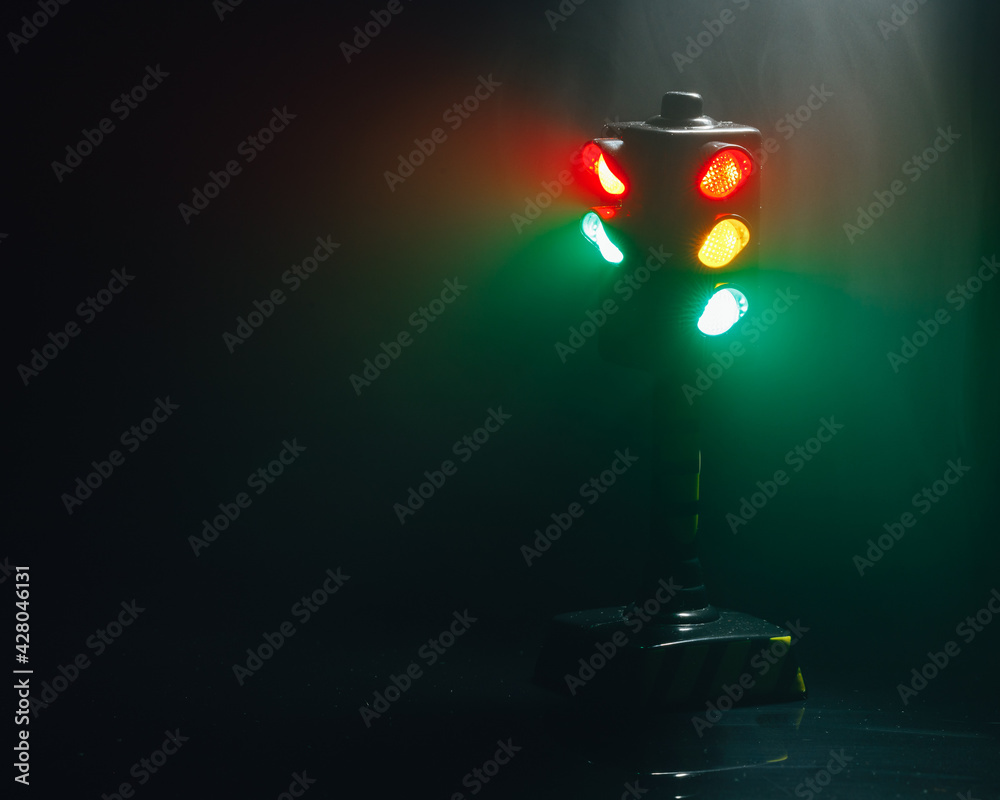 traffic lights at night in dense fog Photos | Adobe Stock