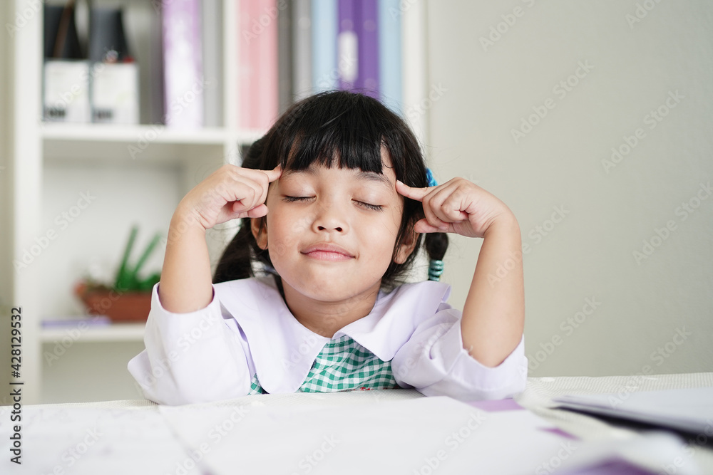 student child girl concentrate and focusing to the homework for ...