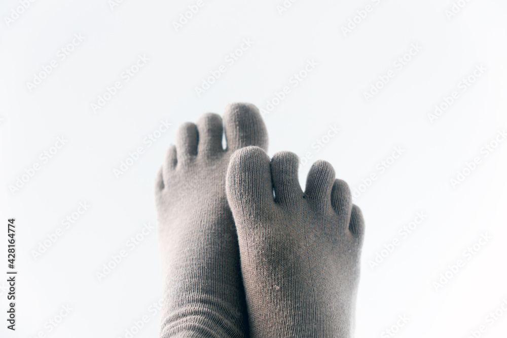 Two feet together with their individual differences. Finger socks ...