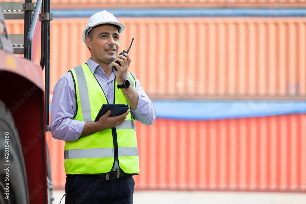 factory worker or engineer using walkie talkie and tablet for preparing ...