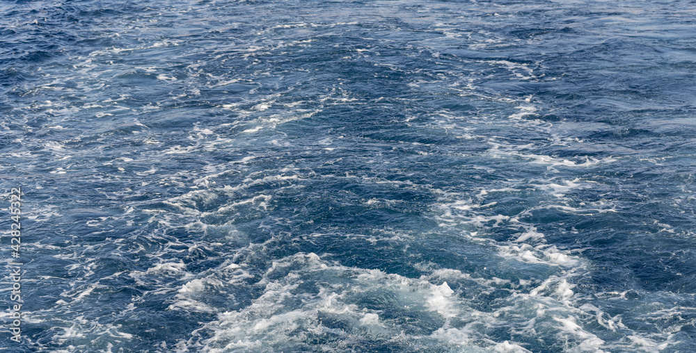 Turbulent flow of a boat wake. Sea wave. The yacht sails, leaving ...
