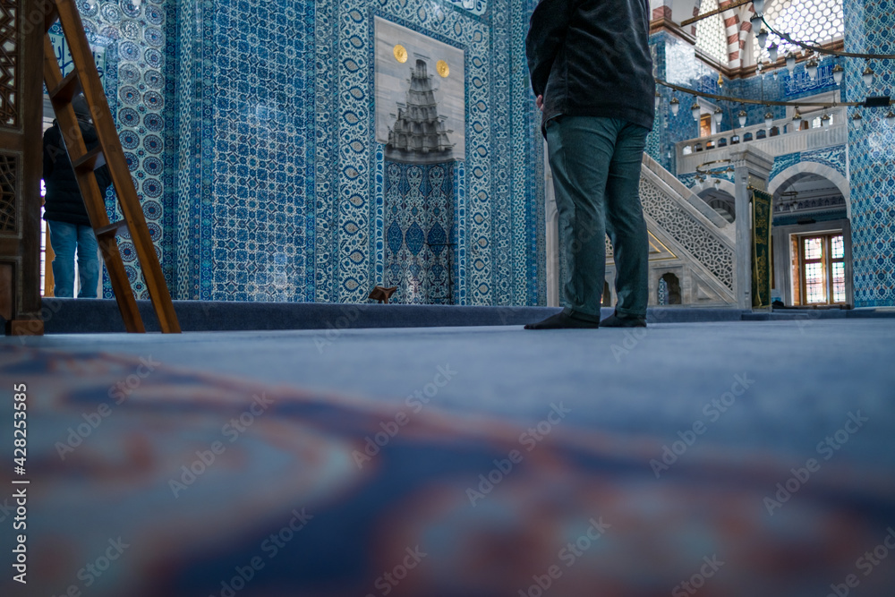 low angle of an unrecognizable Muslim Turkish man praying salah in a ...
