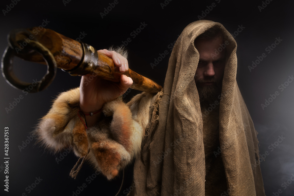 Portrait of a medieval bearded military monk, dressed in animal skins ...
