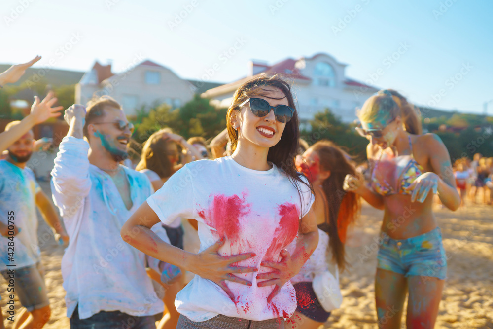 Group of people have fun at the holi festival of colors. Smiling faces ...