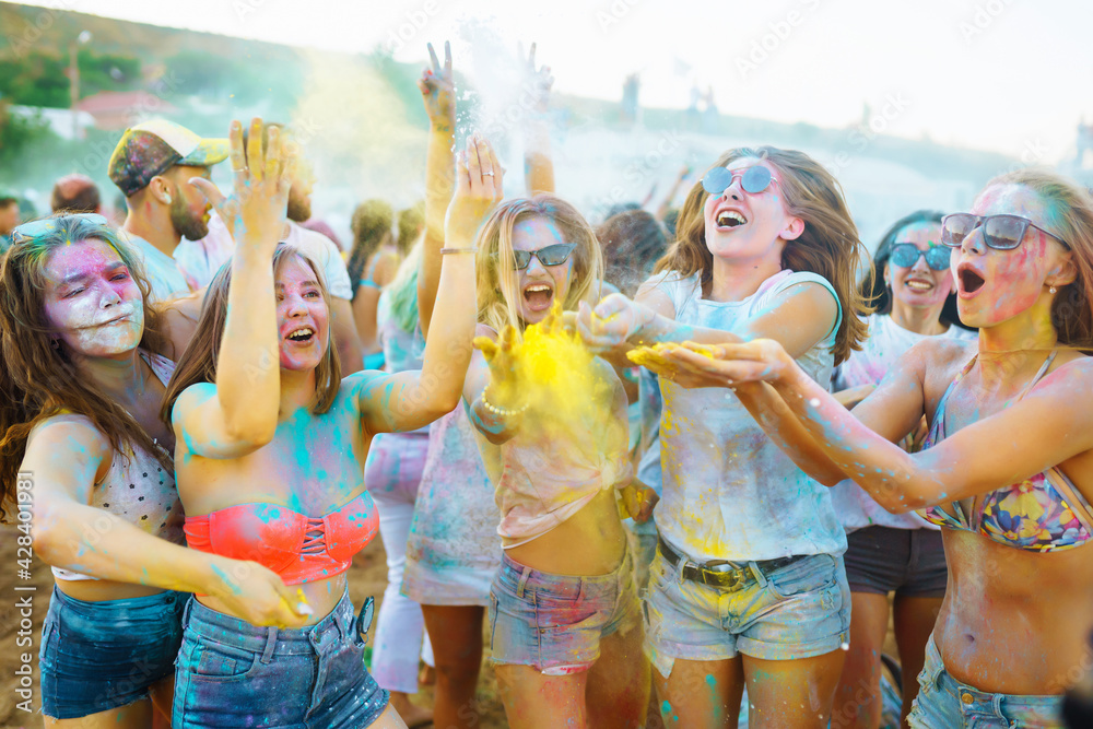 Group of people have fun at the holi festival of colors. Smiling faces ...