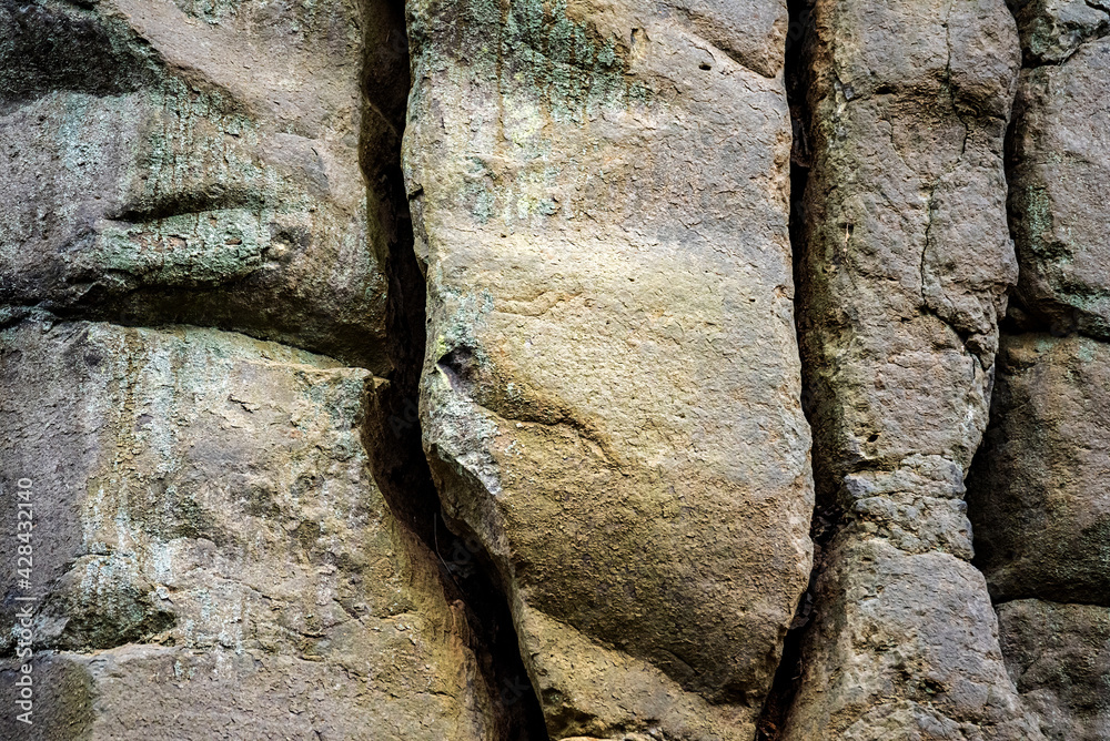 Rock background. Structure of cracked rocks. Gray stones covered with ...