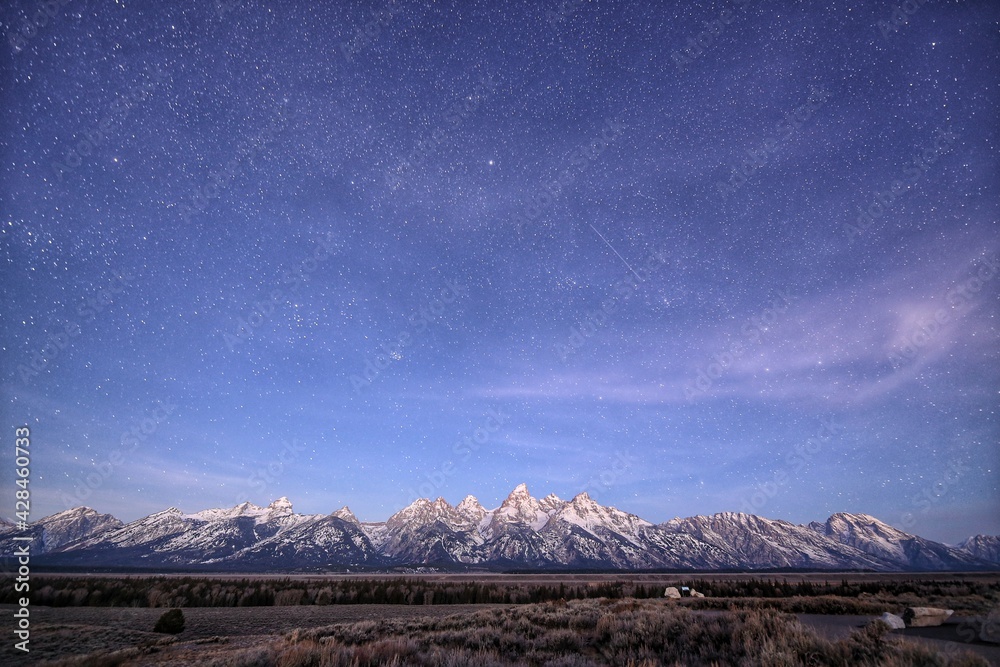 landscape photo of stars light over Grand Teton mountains in Grand ...