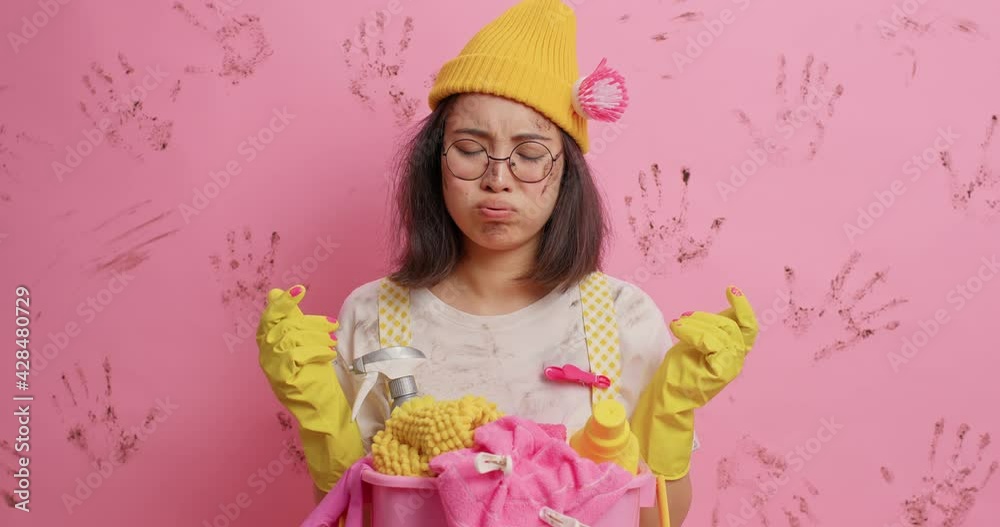Frustrated overworked Asian woman maid looks with dissatisfied tired ...