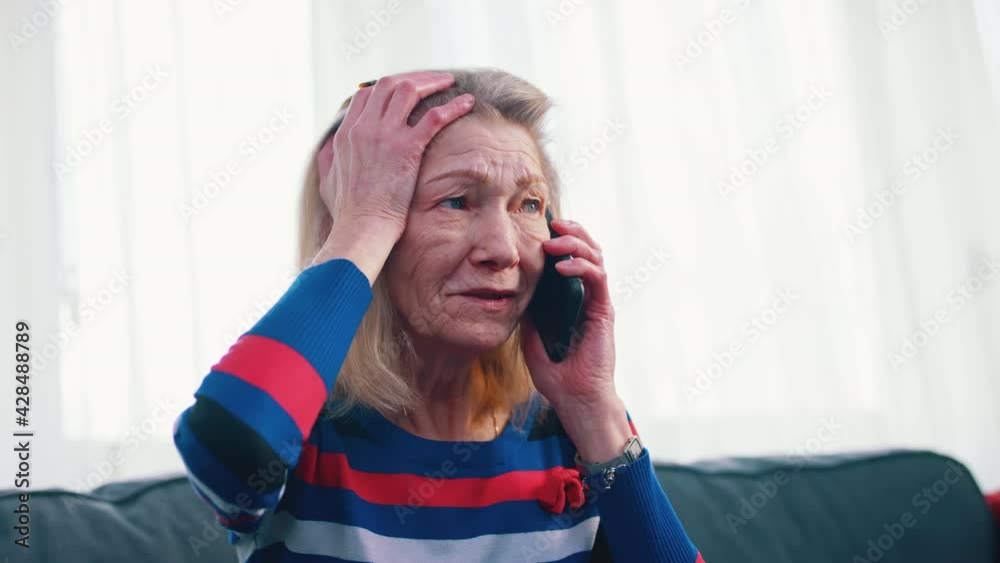 Desperate worried elderly woman having a phone call. High quality 4k ...