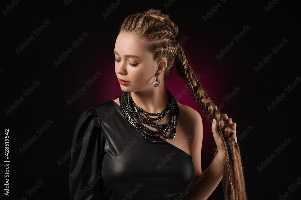 Beautiful young woman with braided hair on dark background Stock Photo ...